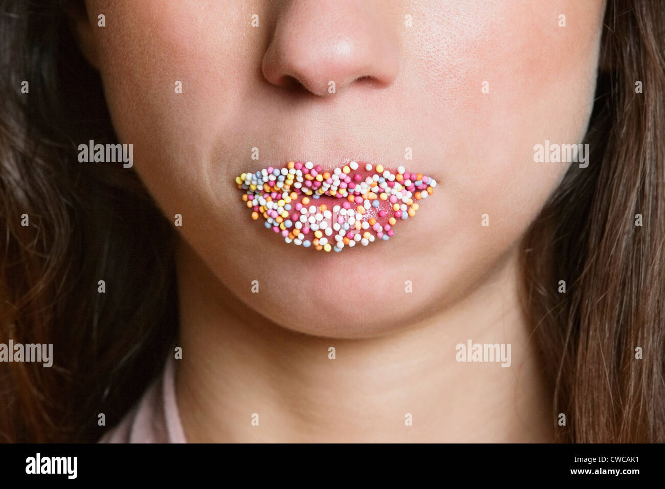 Candy into the mouth hi-res stock photography and images - Alamy