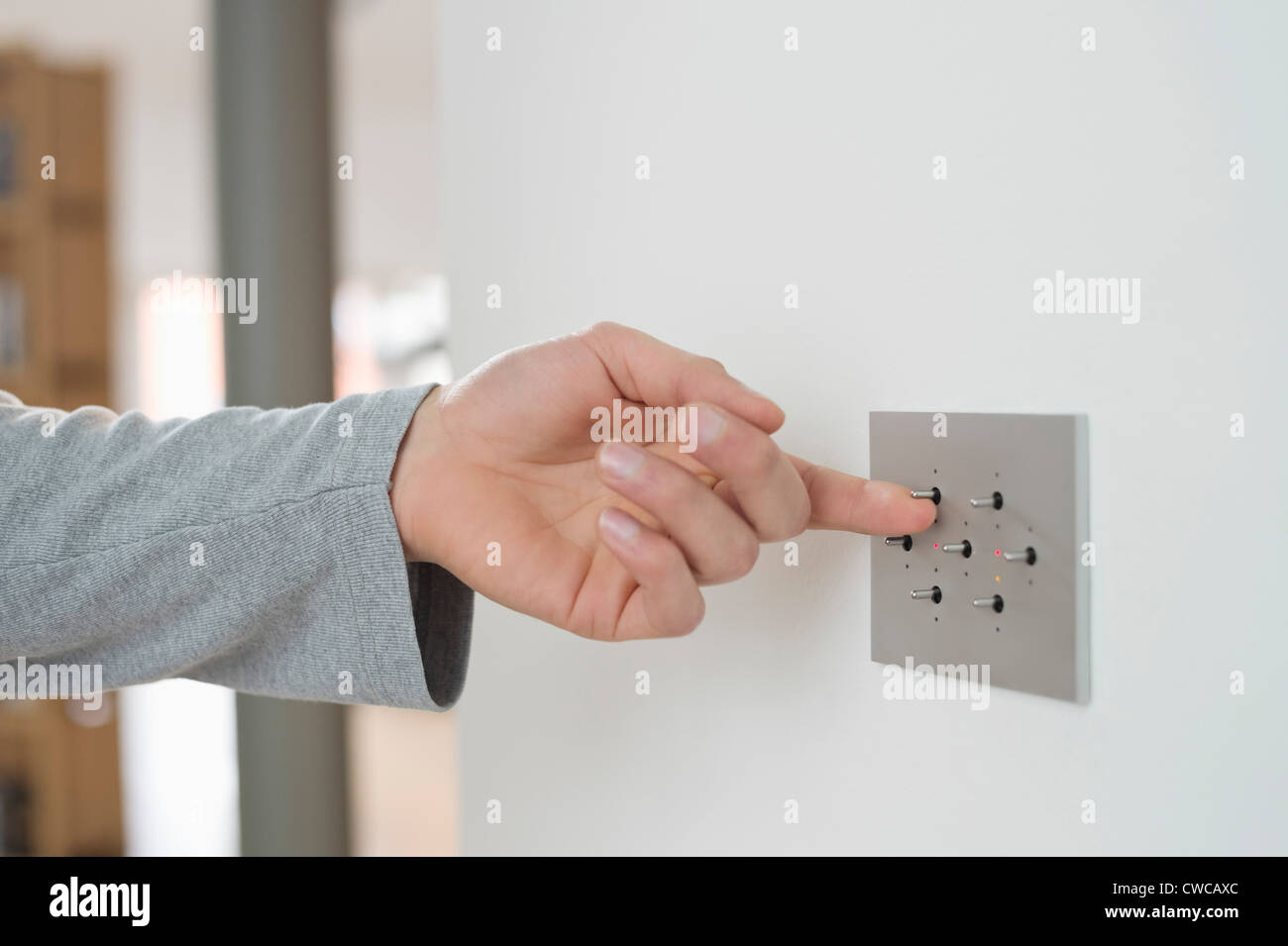 Close-up of a man's hand pressing light switch on a wall Stock Photo ...