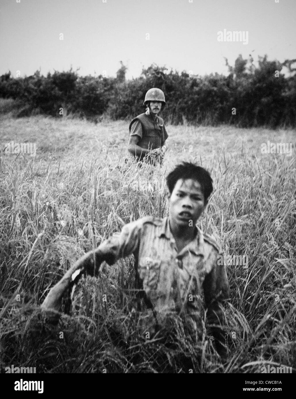 US Marine with Viet Cong POW. A marine guards a Viet Cong as he moves ...