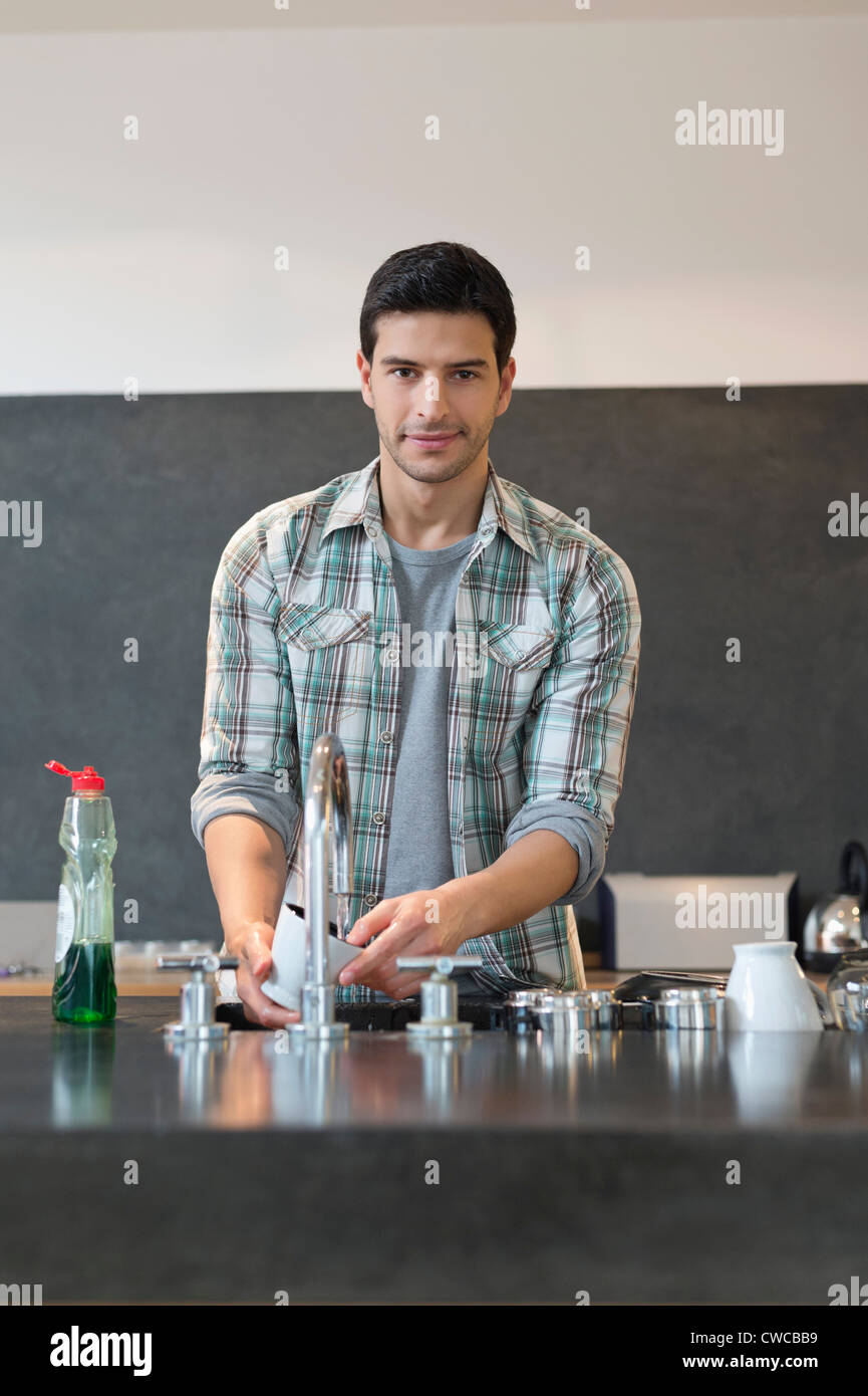 Man washing dishes in the kitchen Stock Photo - Alamy