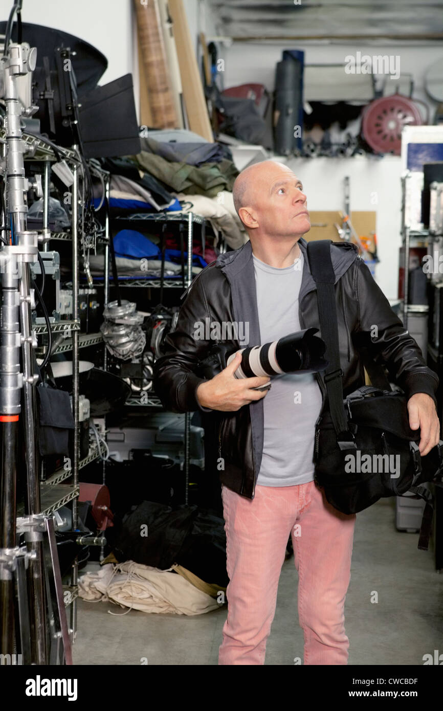 Front view of senior photographer looking up in studio Stock Photo - Alamy