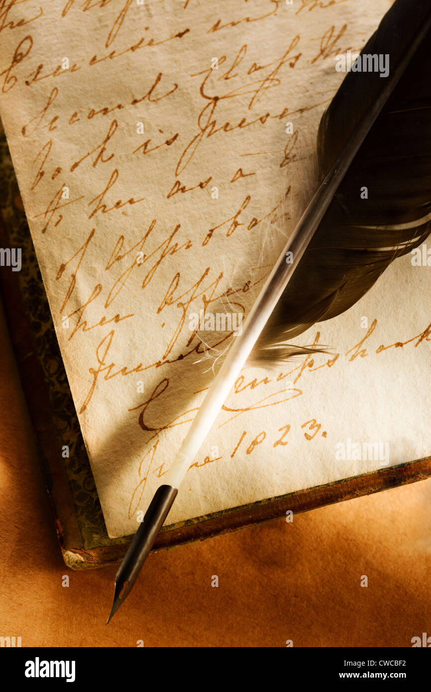 Old book with feather pen Stock Photo - Alamy