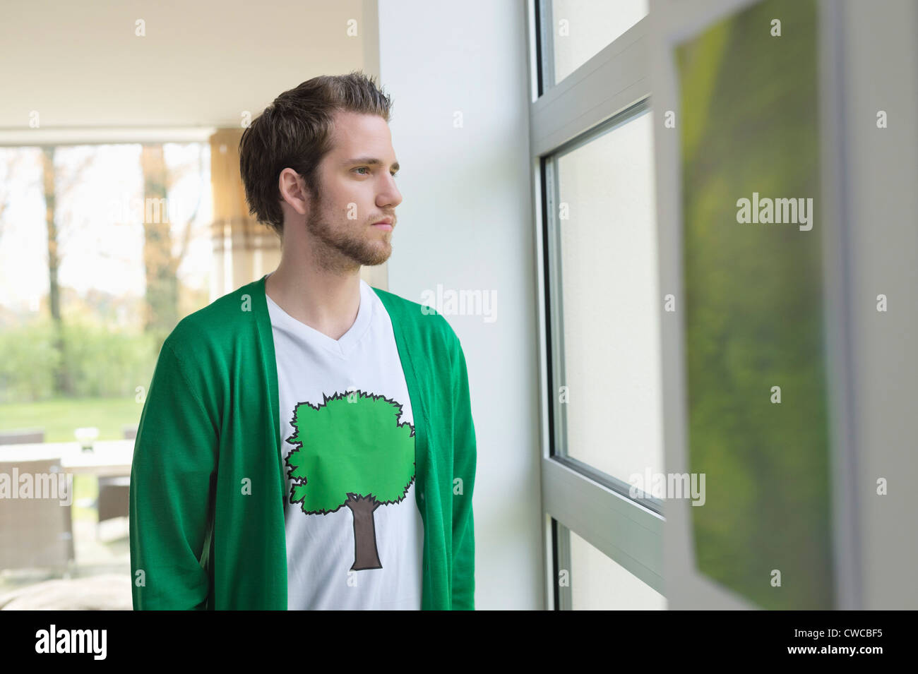 Man looking through a window Stock Photo - Alamy