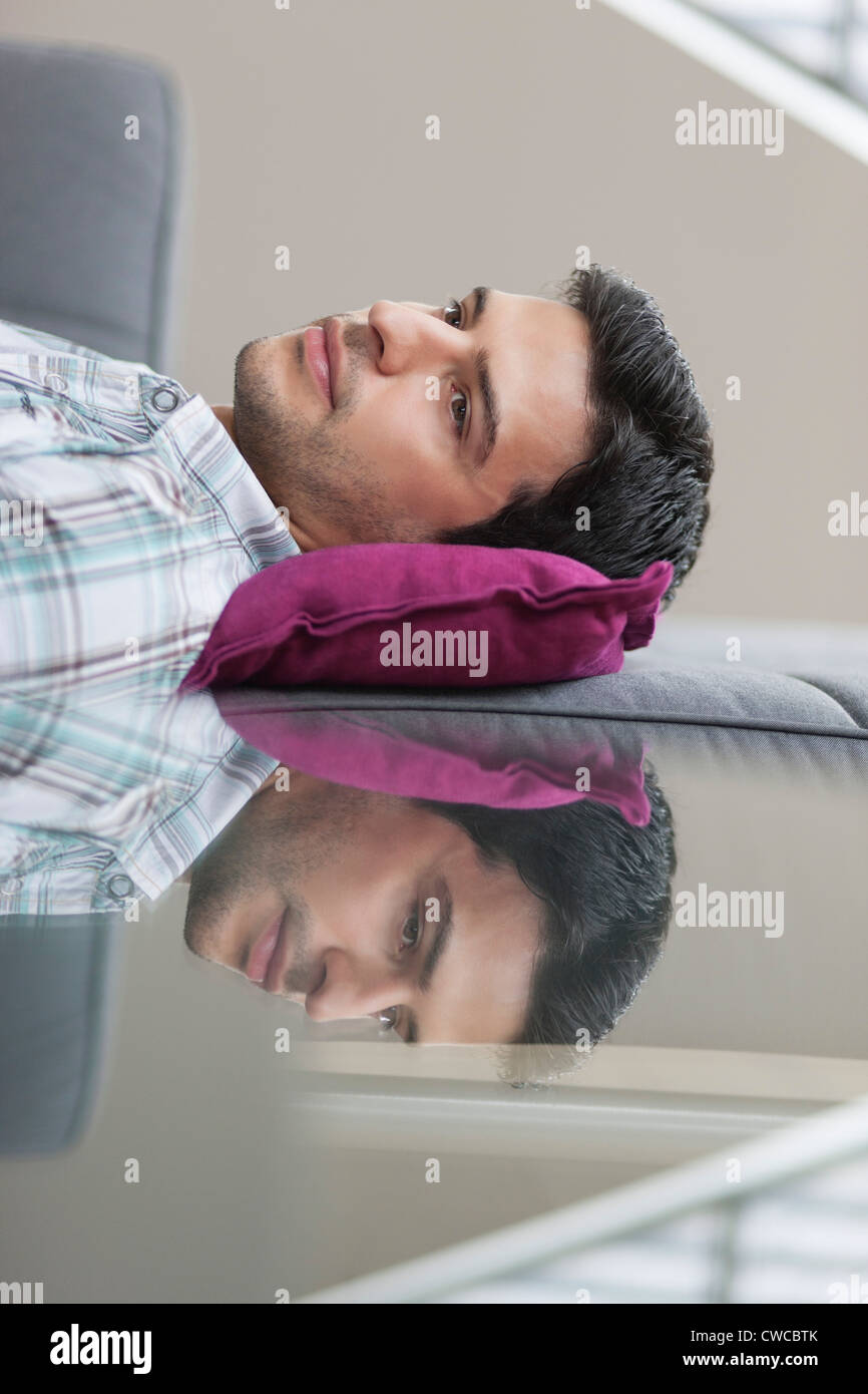 Man resting on a couch Stock Photo - Alamy
