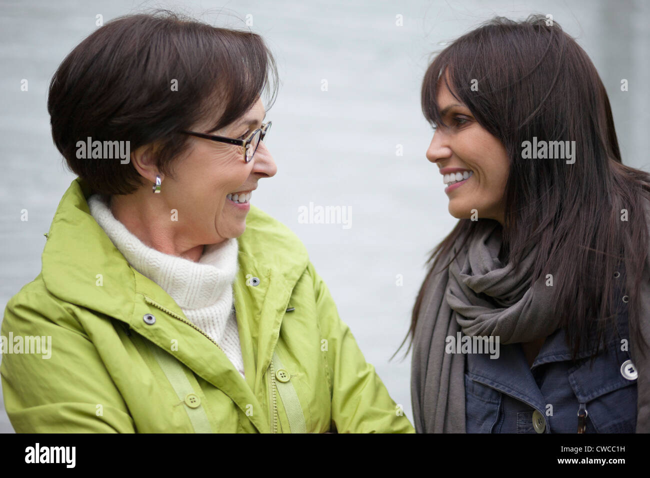 Two women talking to each other Stock Photo - Alamy