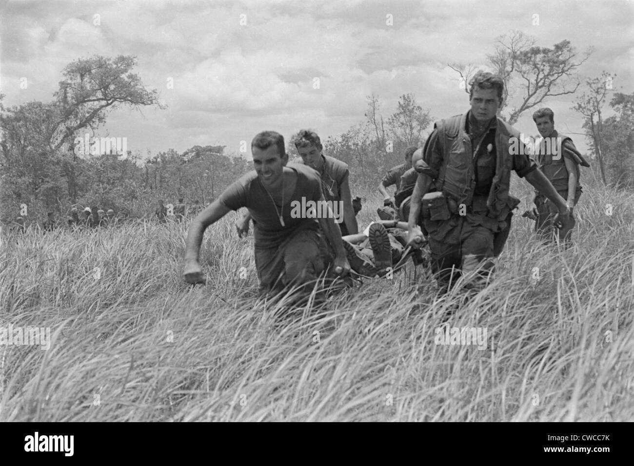 Vietnam War. While under heavy fire, US Marines are carry a wounded ...
