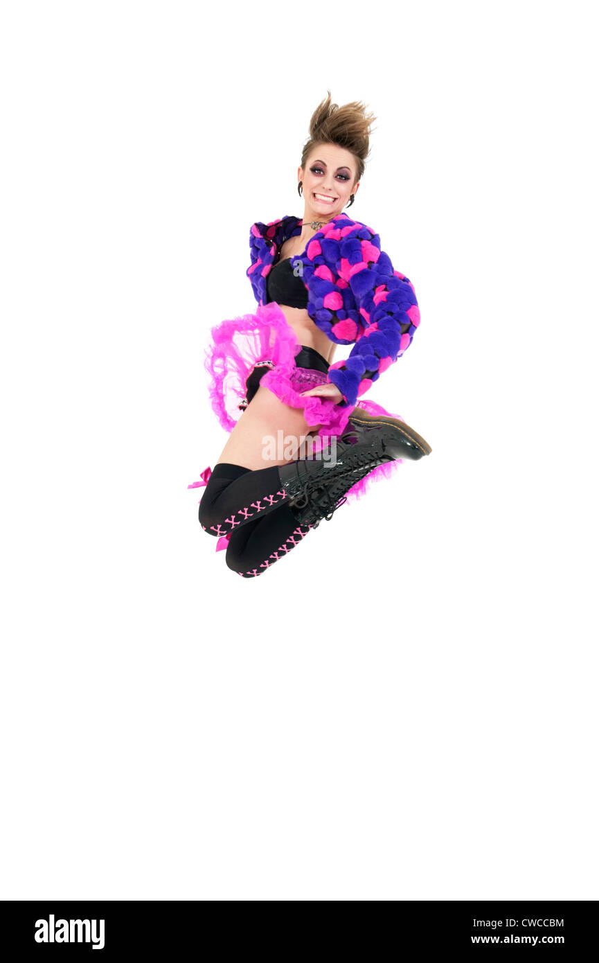 Happy young punk woman jumping over white background Stock Photo - Alamy