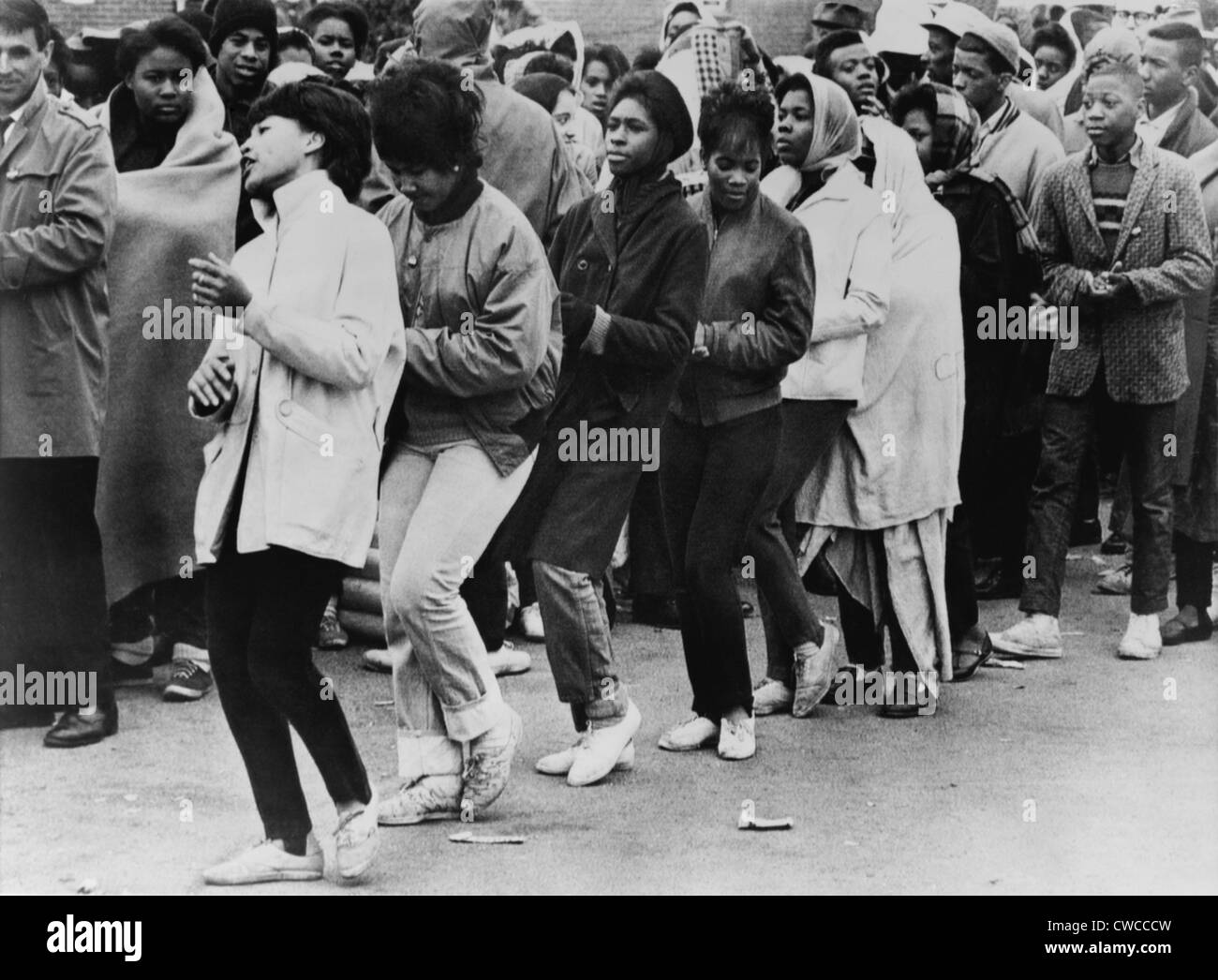 African American women dance at a civil rights demonstration. Over the ...