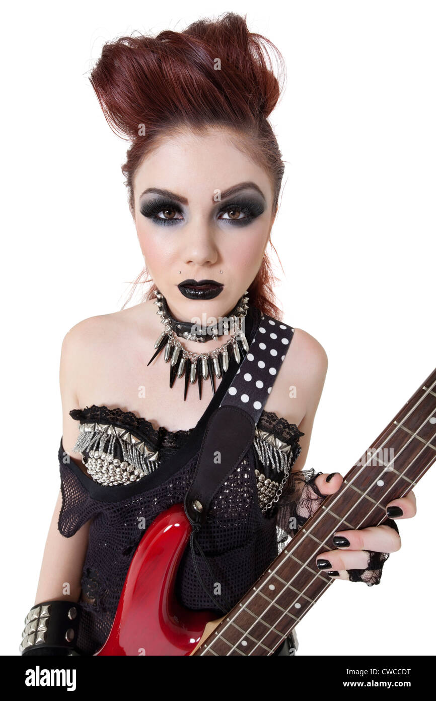 Portrait beautiful punk woman staring while holding guitar over white ...