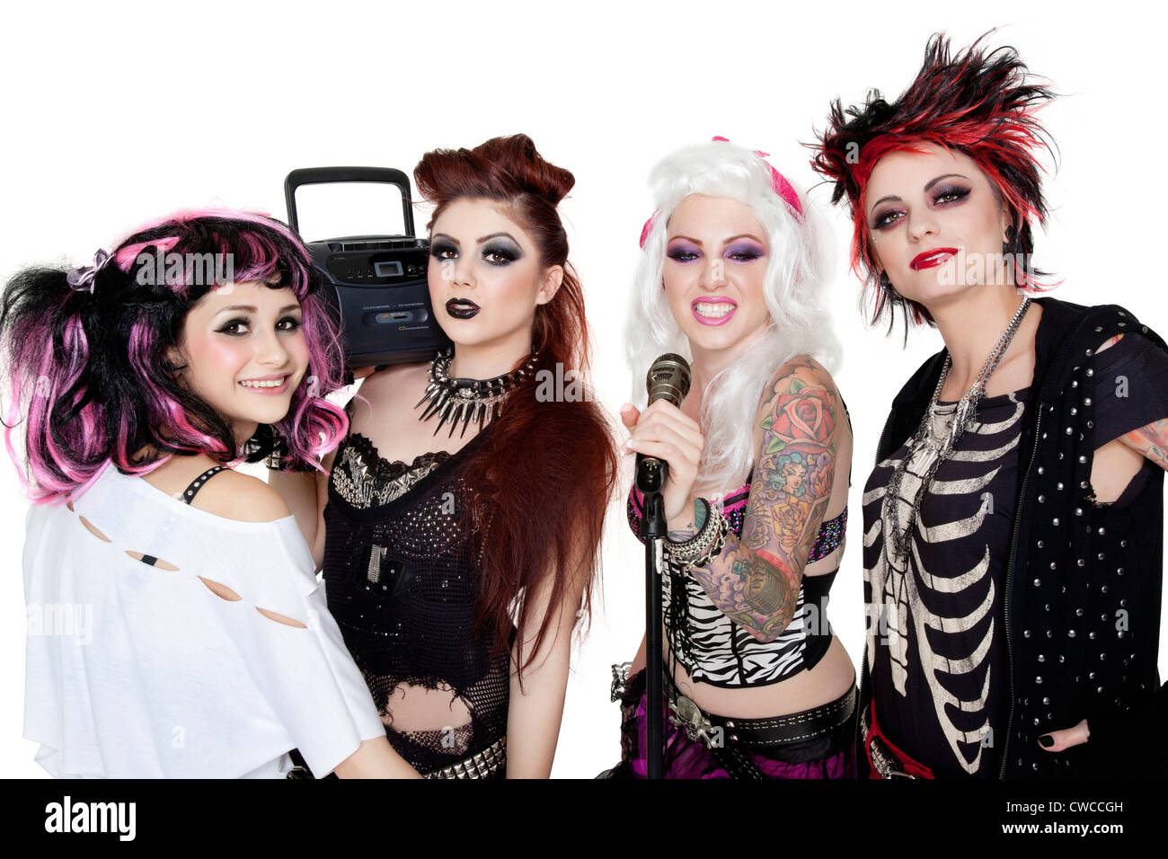 Portrait of all female band with microphone and boom box over white ...