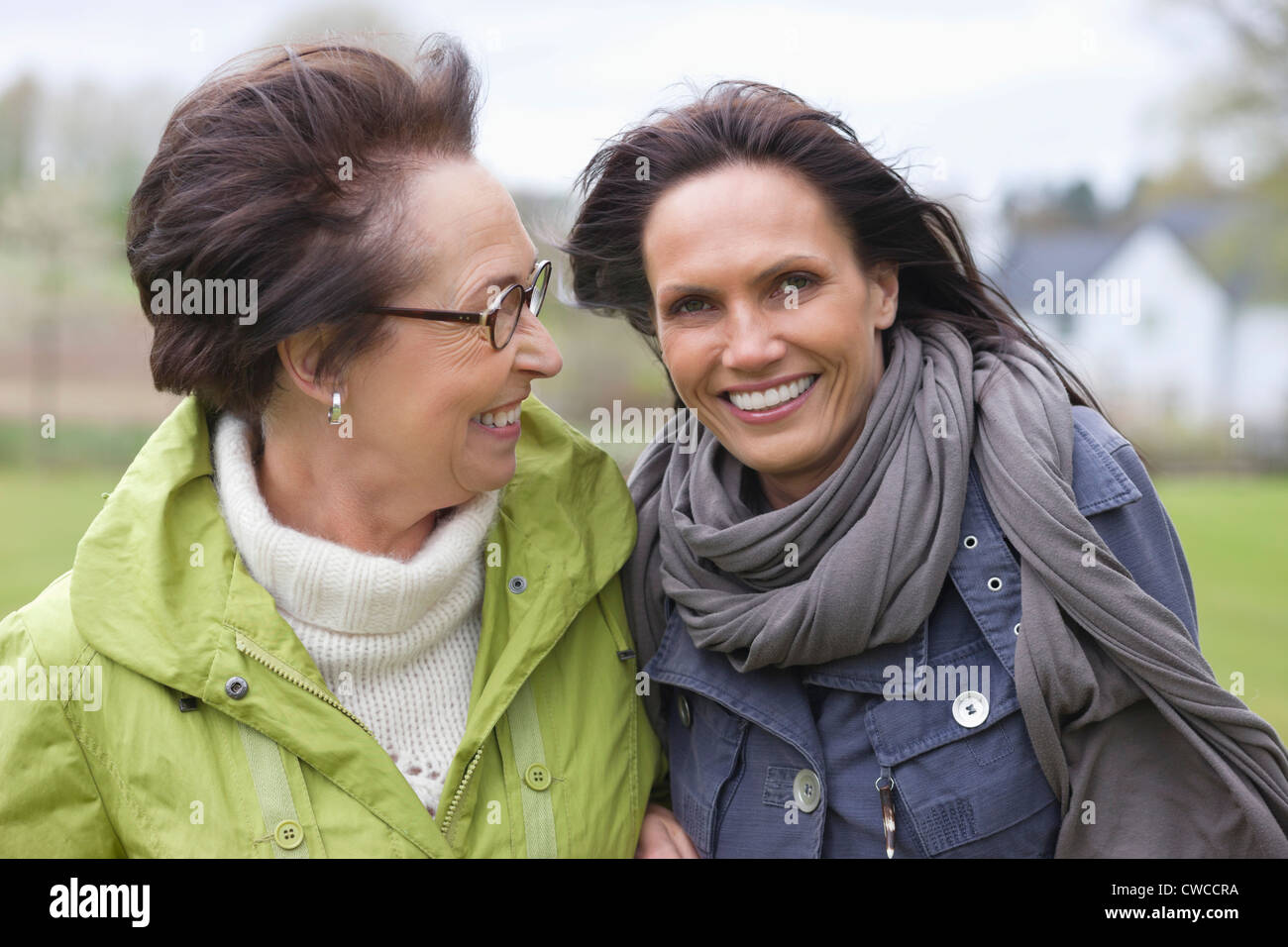 Two women laughing in park Stock Photo - Alamy