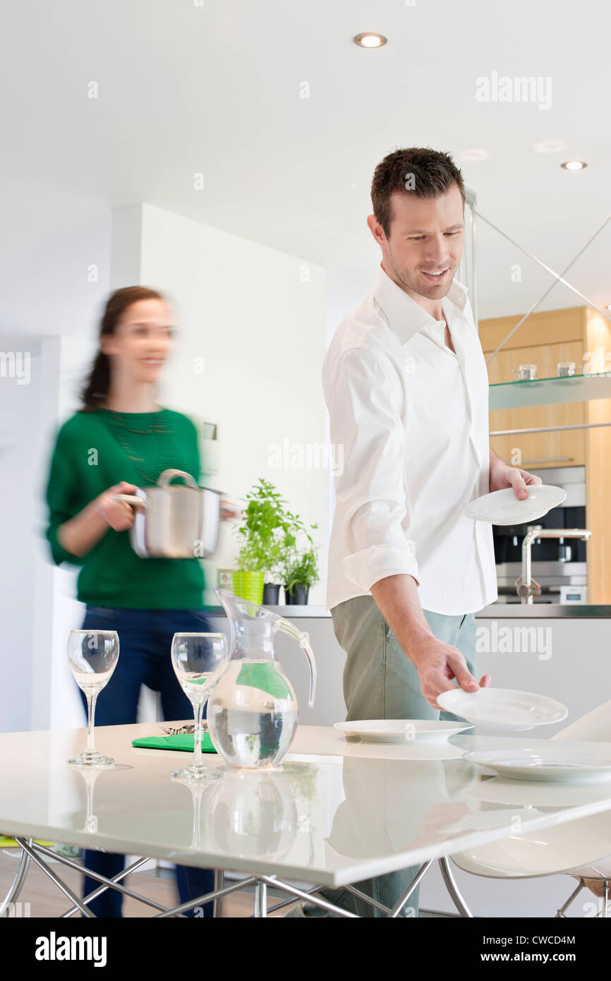 Couple preparing to serve dinner Stock Photo - Alamy