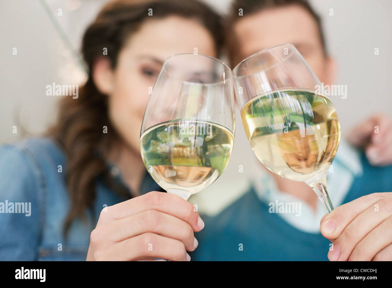 Couple toasting with wine Stock Photo - Alamy