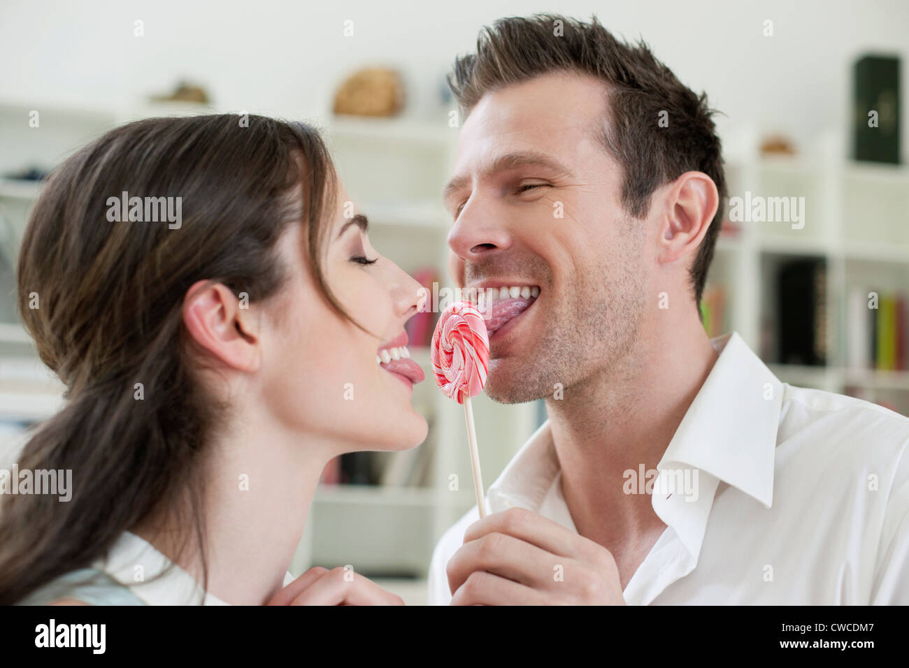 Couple sharing a candy Stock Photo - Alamy