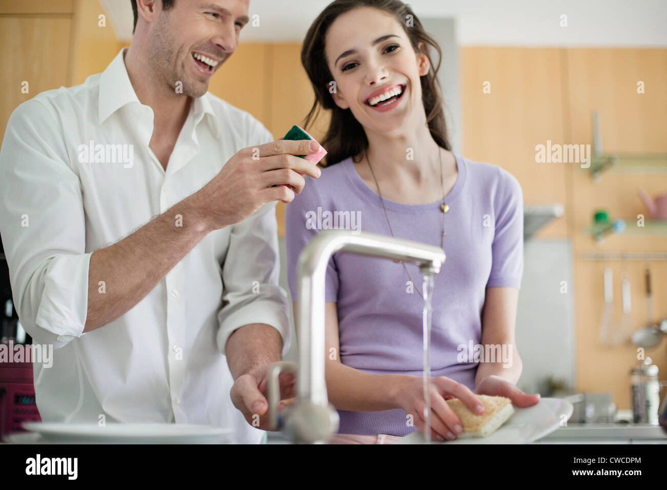Woman washing utensils in the kitchen Stock Photo - Alamy