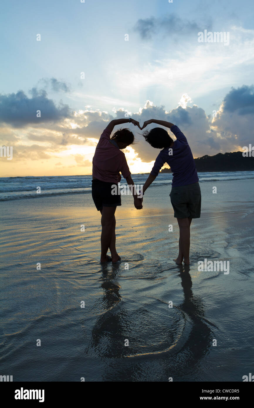Couple making heart arms together hi-res stock photography and images ...
