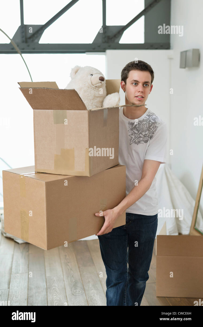 Man carrying cardboard boxes Stock Photo - Alamy