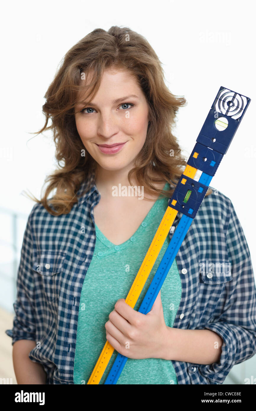 Portrait of a woman holding a level Stock Photo - Alamy