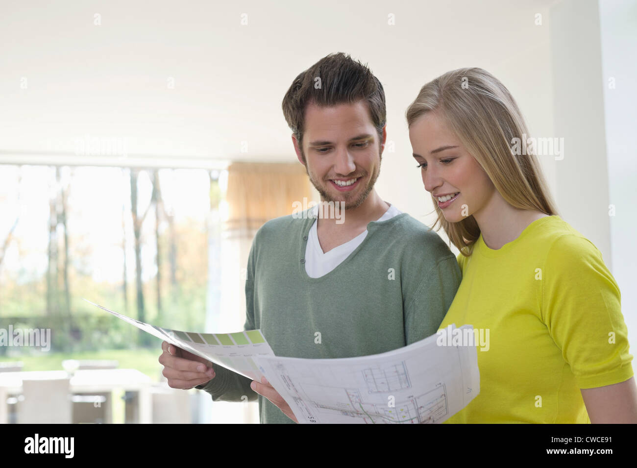 Couple choosing color for their house from a color chart Stock Photo ...