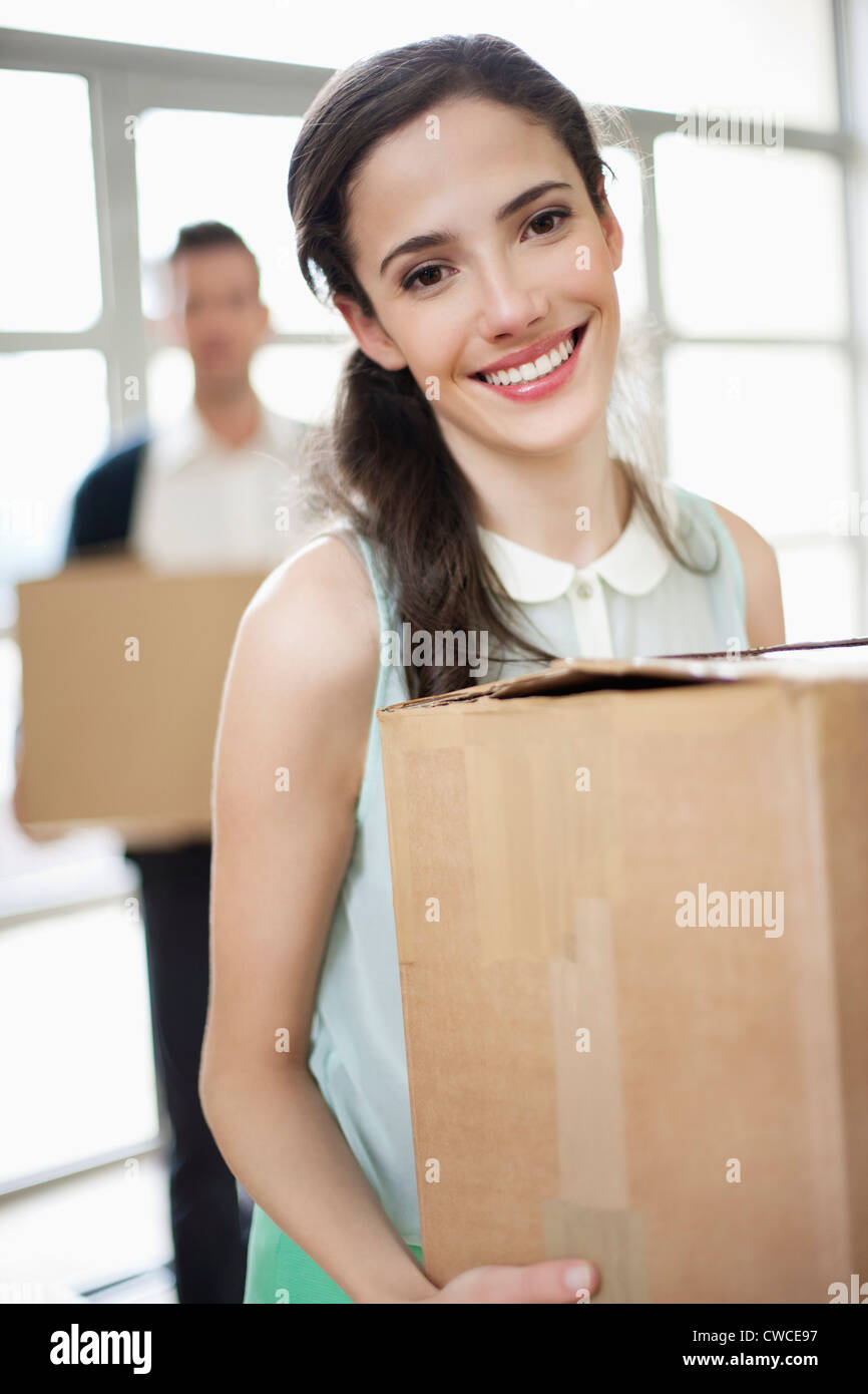 Couple carrying cardboard boxes at their new home Stock Photo - Alamy