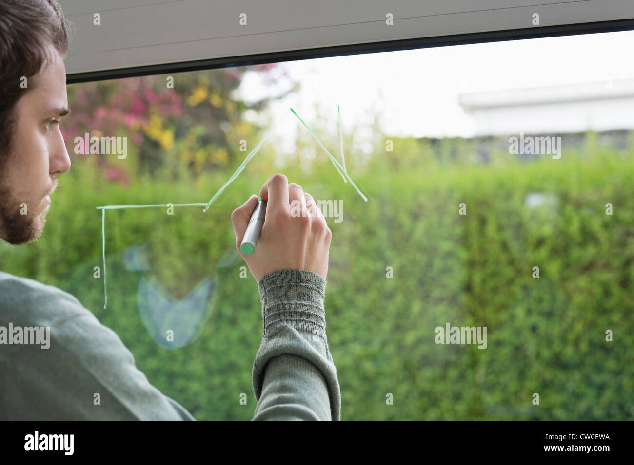 Man drawing an architecture design on the glass of window Stock Photo ...