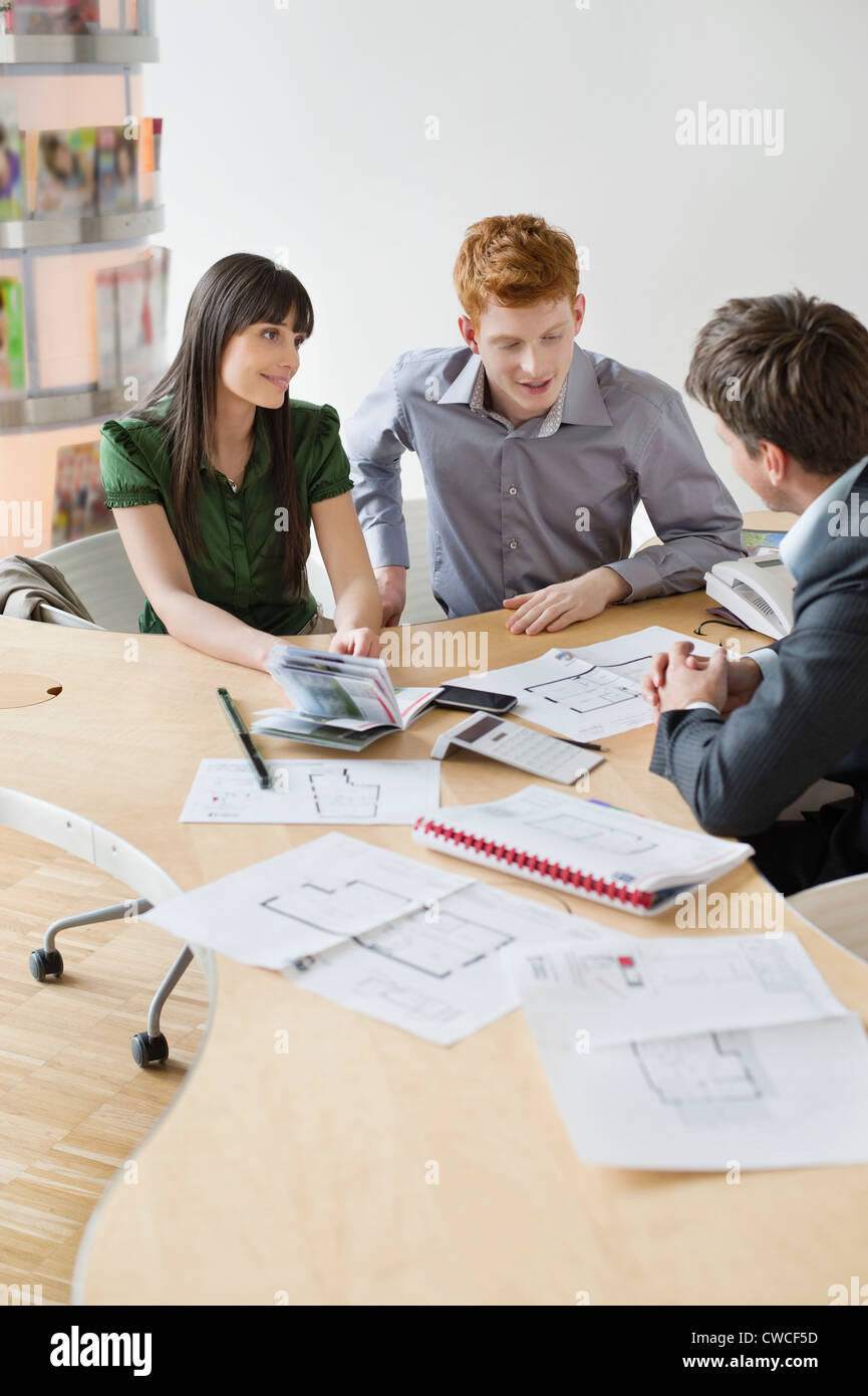 Real estate agent discussing property documents to his clients Stock ...