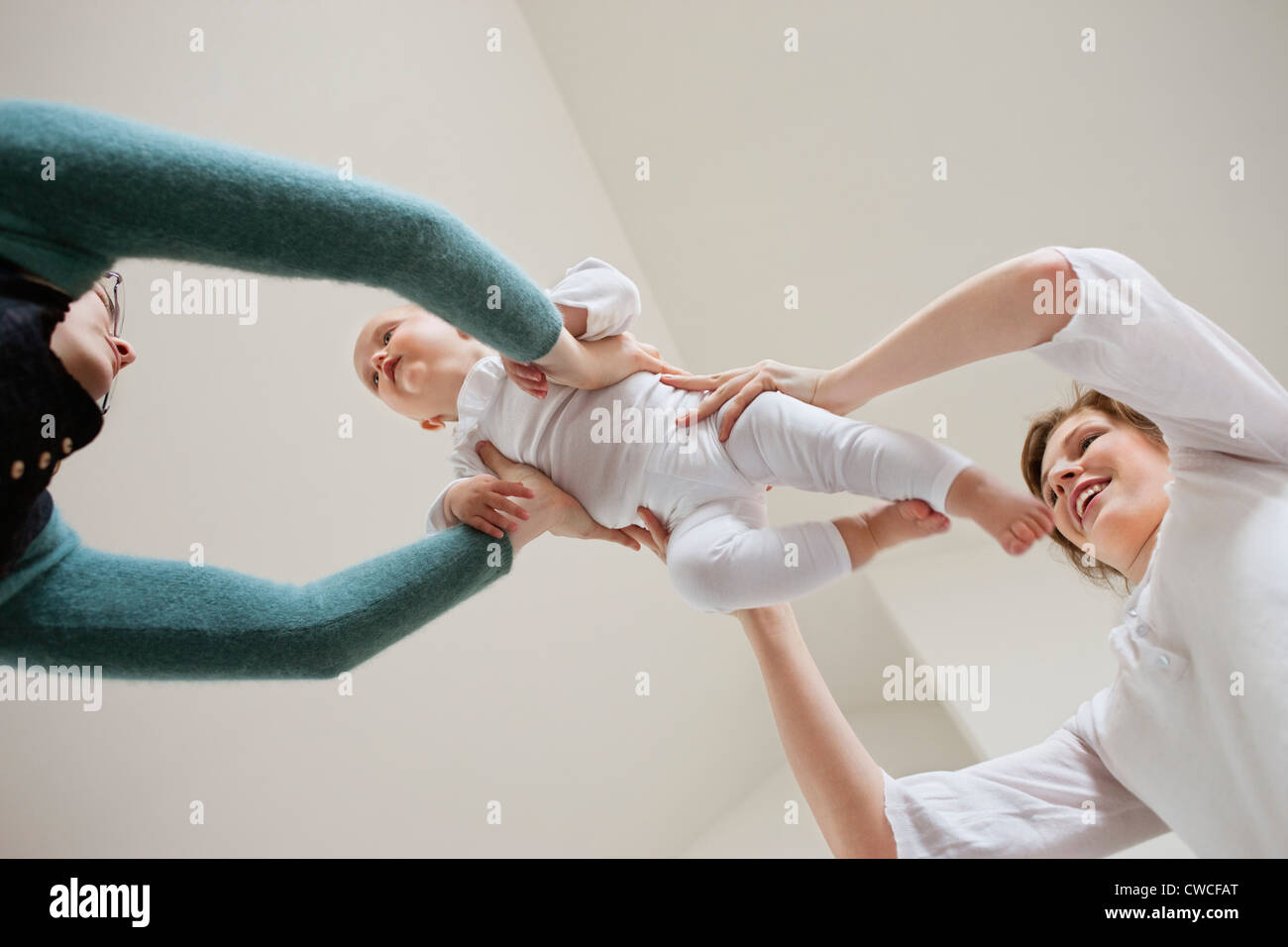 Woman giving her baby to another woman Stock Photo - Alamy