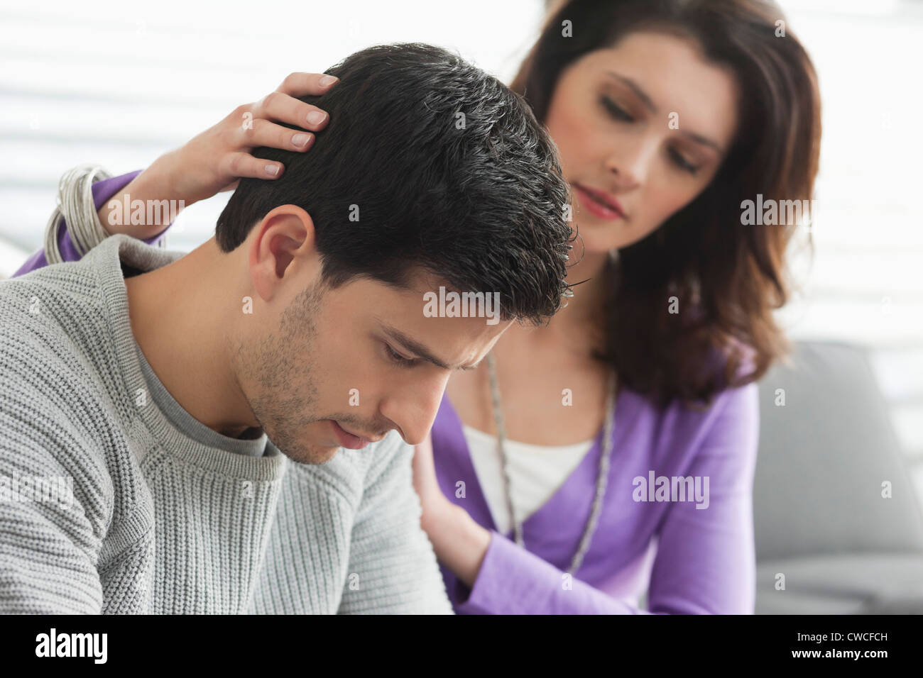 Woman comforting her husband Stock Photo - Alamy