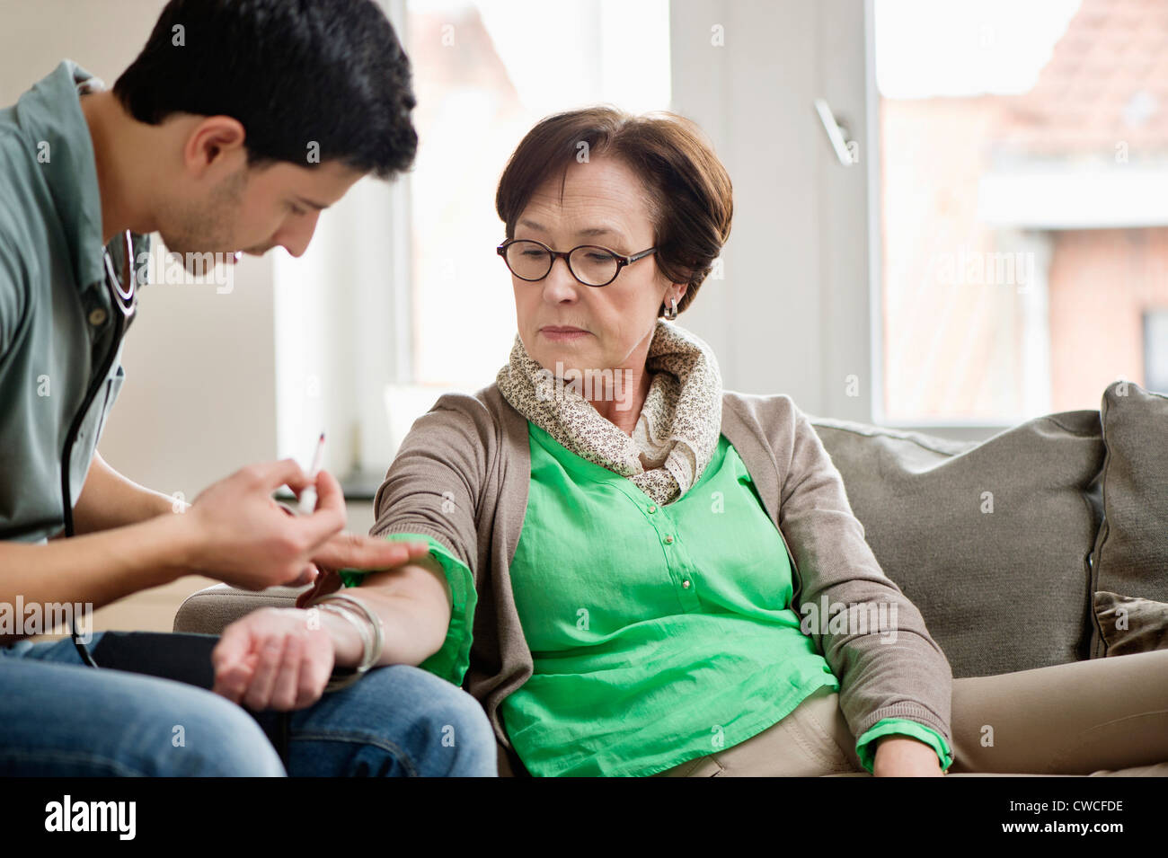 Male doctor giving an injection to a patient Stock Photo - Alamy