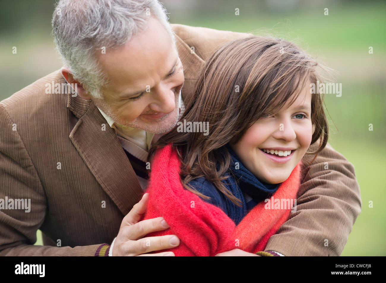 Man hugging his daughter in a park Stock Photo - Alamy