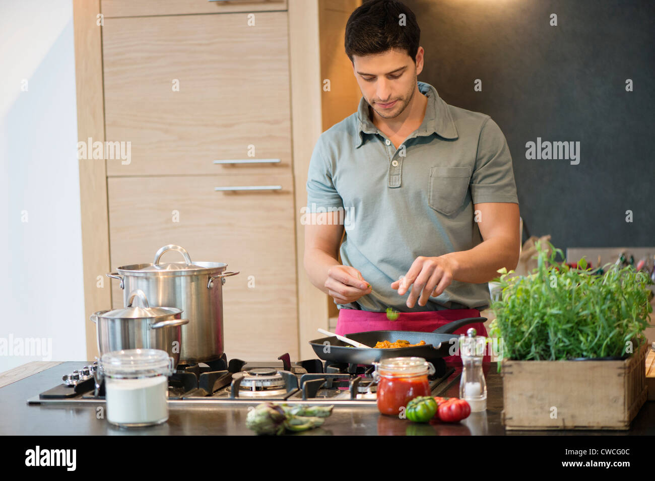 Man preparing food in the kitchen Stock Photo - Alamy