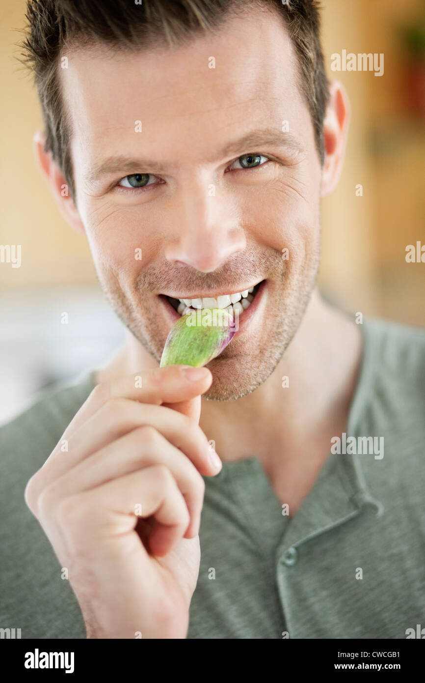 Man eating an artichoke Stock Photo - Alamy