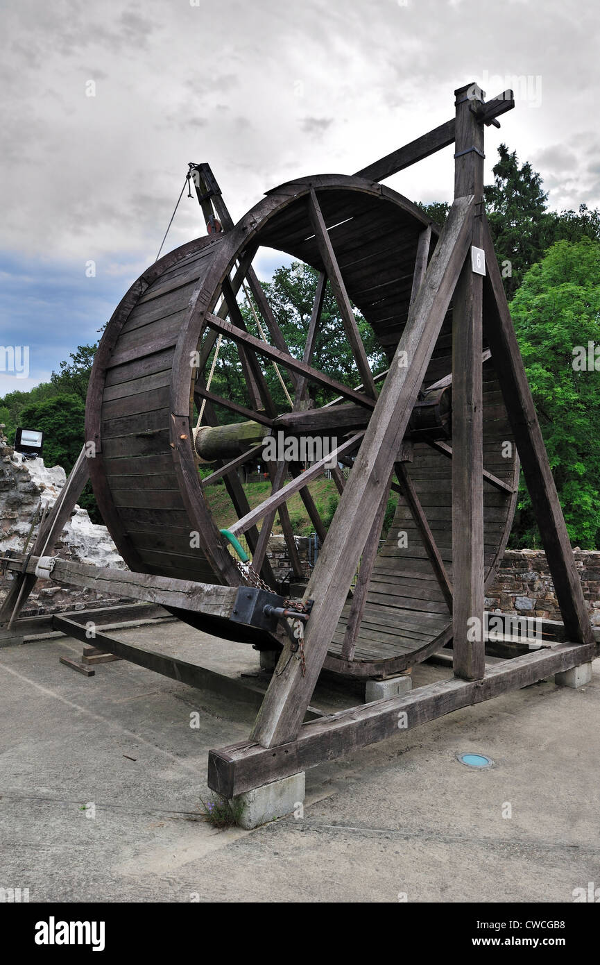 Wooden treadwheel crane in ruins of medieval castle Château de ...