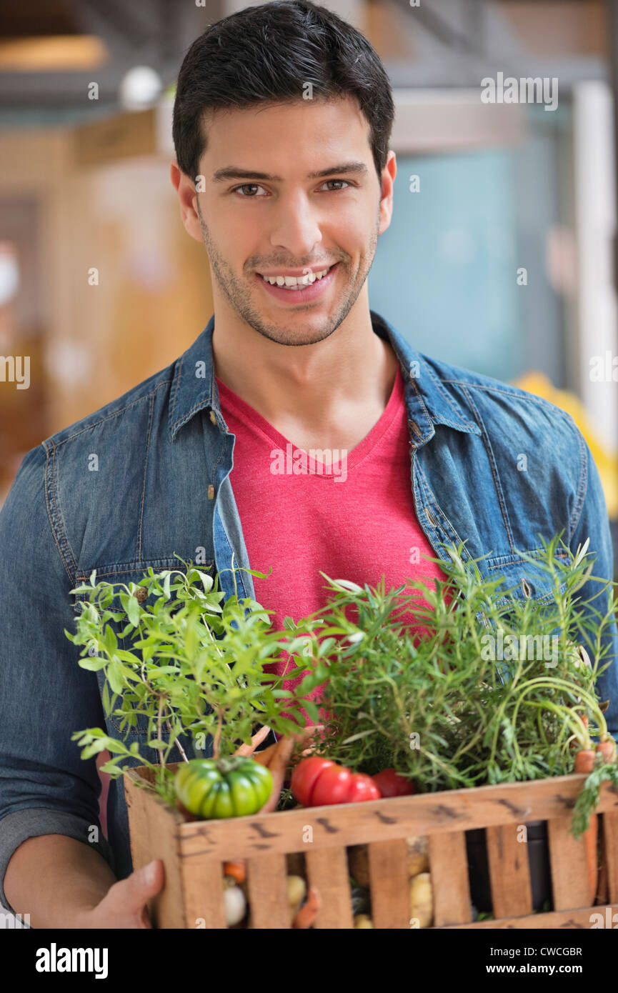 Man carrying fresh vegetables in a crate Stock Photo - Alamy