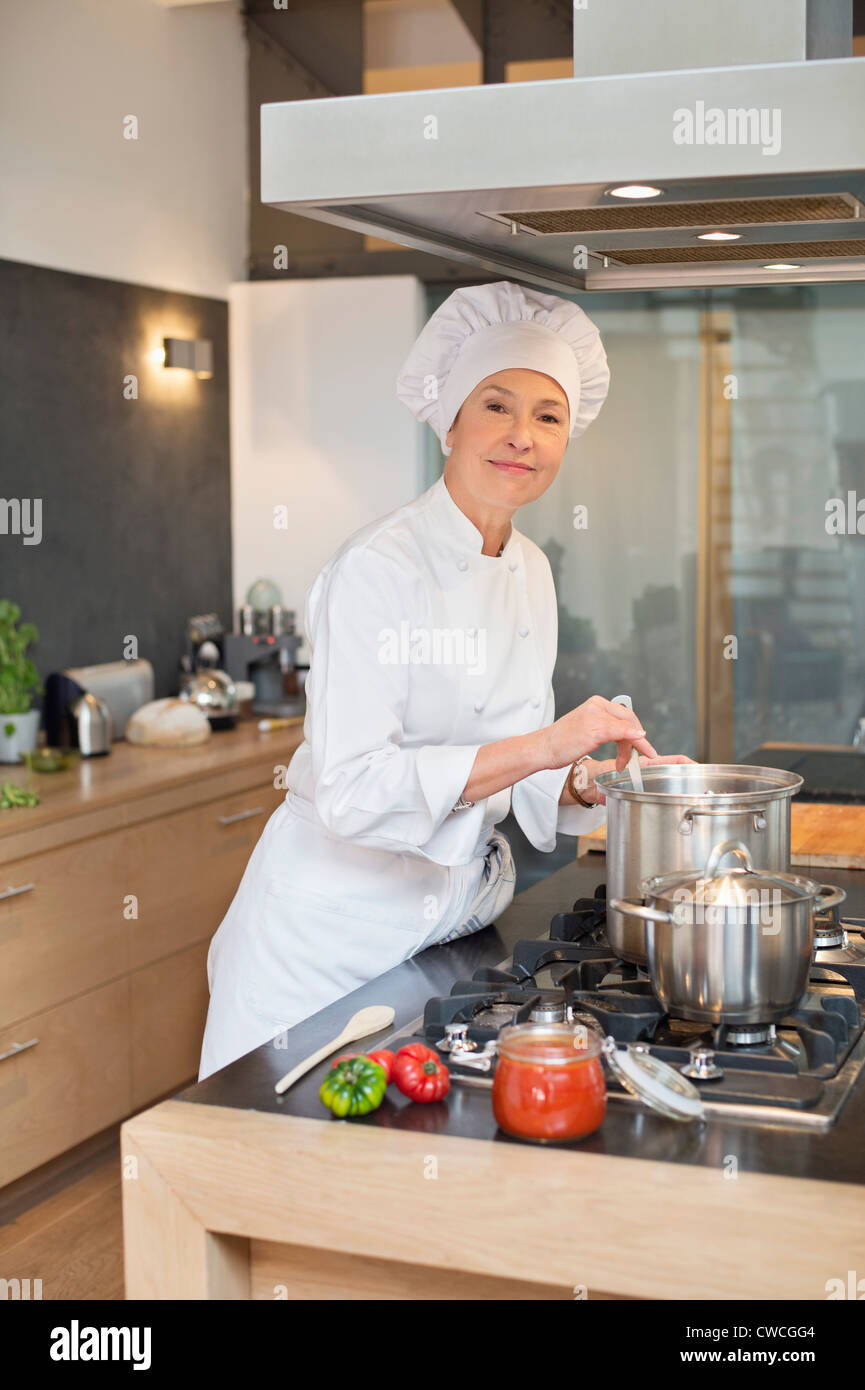 Woman cooking food in the kitchen Stock Photo - Alamy