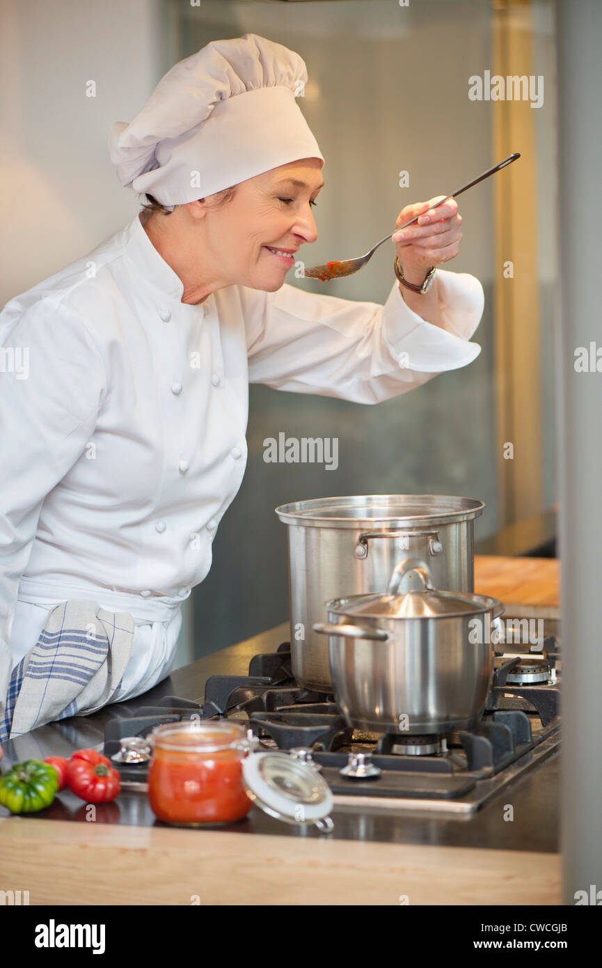Woman tasting food Stock Photo - Alamy