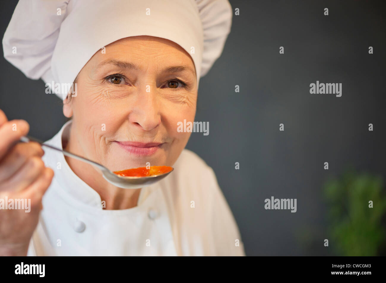 Woman tasting food Stock Photo - Alamy