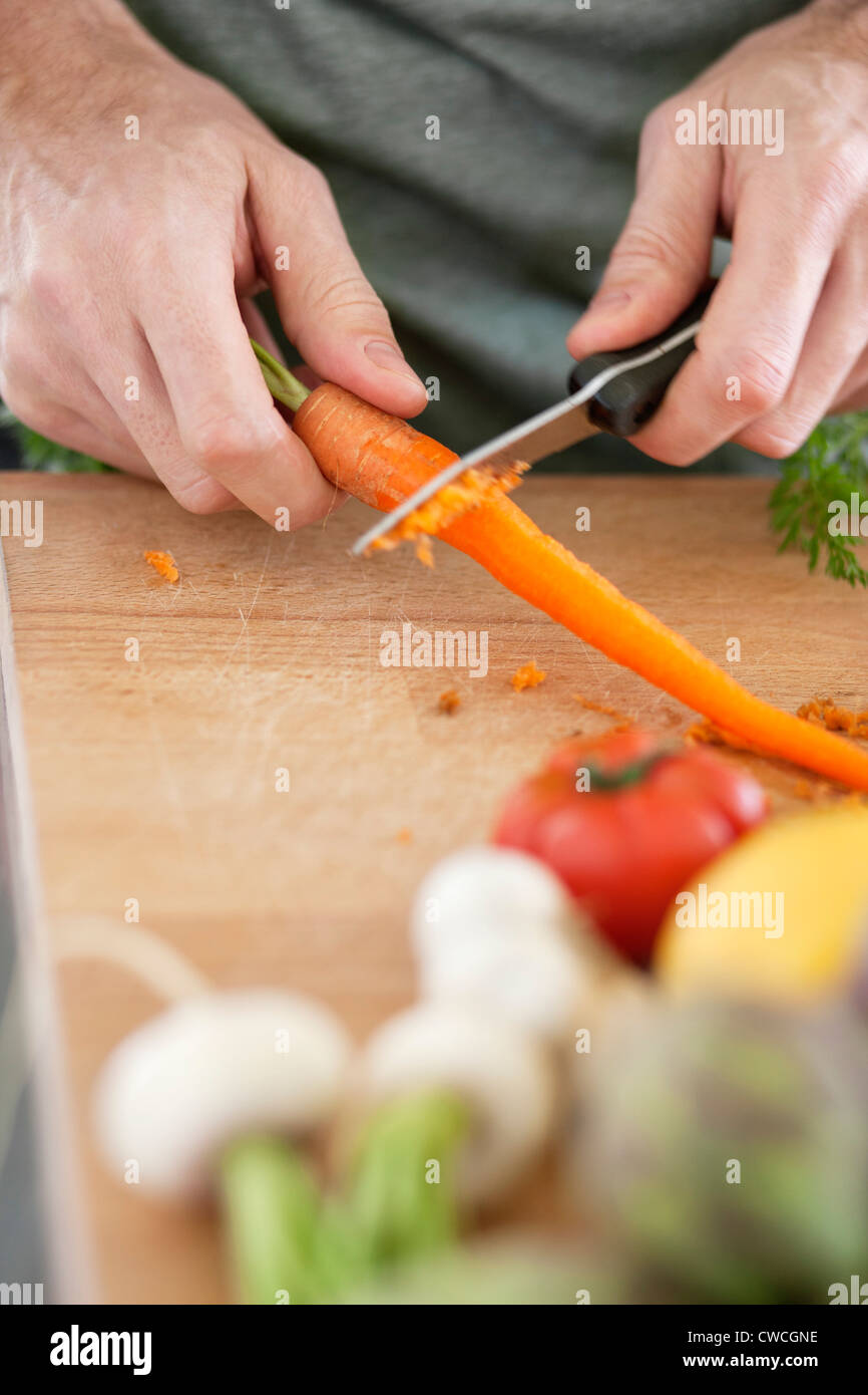 Man cutting carrot Stock Photo - Alamy