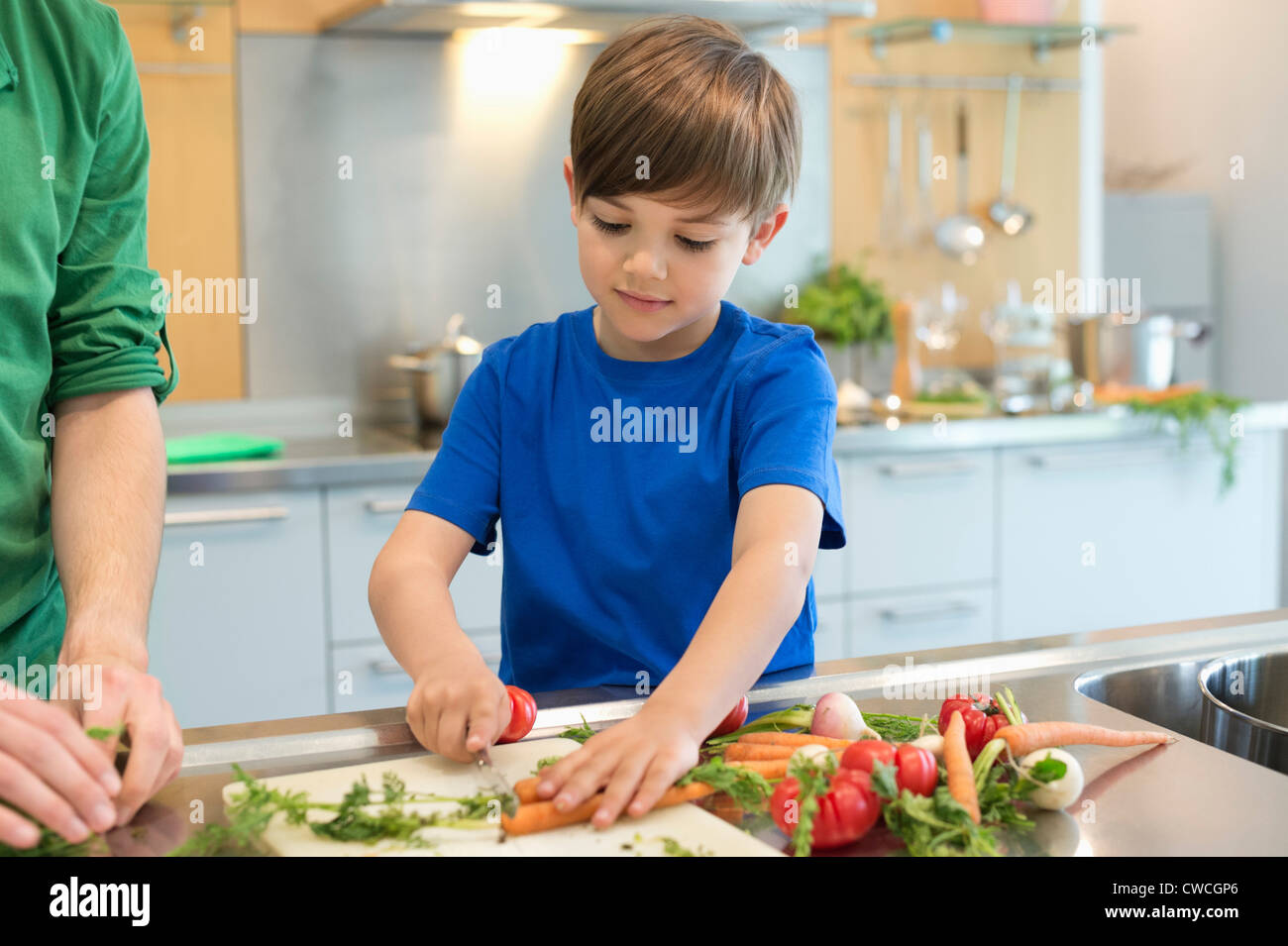Boy cutting vegetables in the kitchen Stock Photo - Alamy