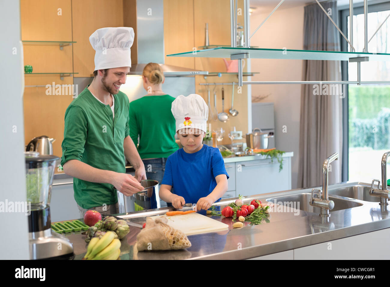 Family cooking in the kitchen Stock Photo - Alamy