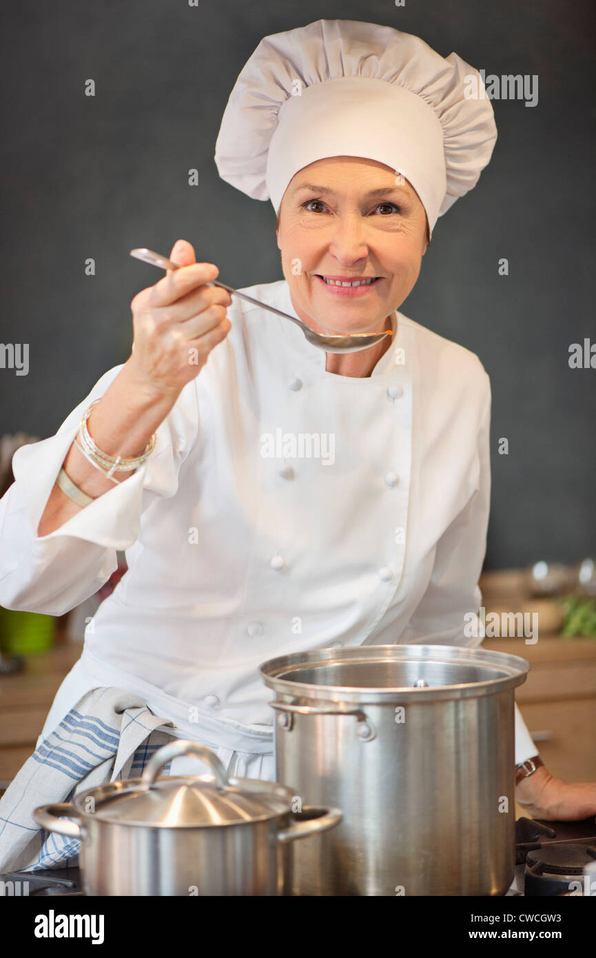 Woman tasting food Stock Photo - Alamy