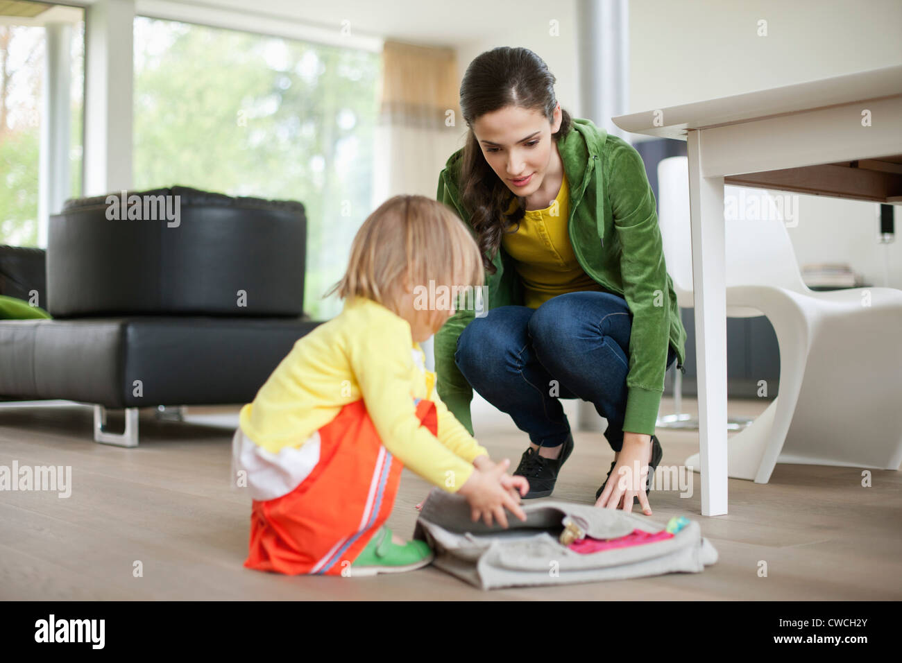 Woman helping her daughter to get ready for school Stock Photo - Alamy