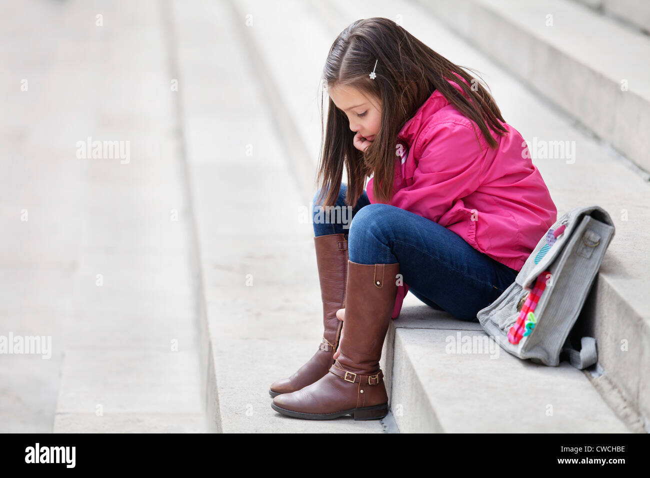 Girl sitting on the steps Stock Photo - Alamy