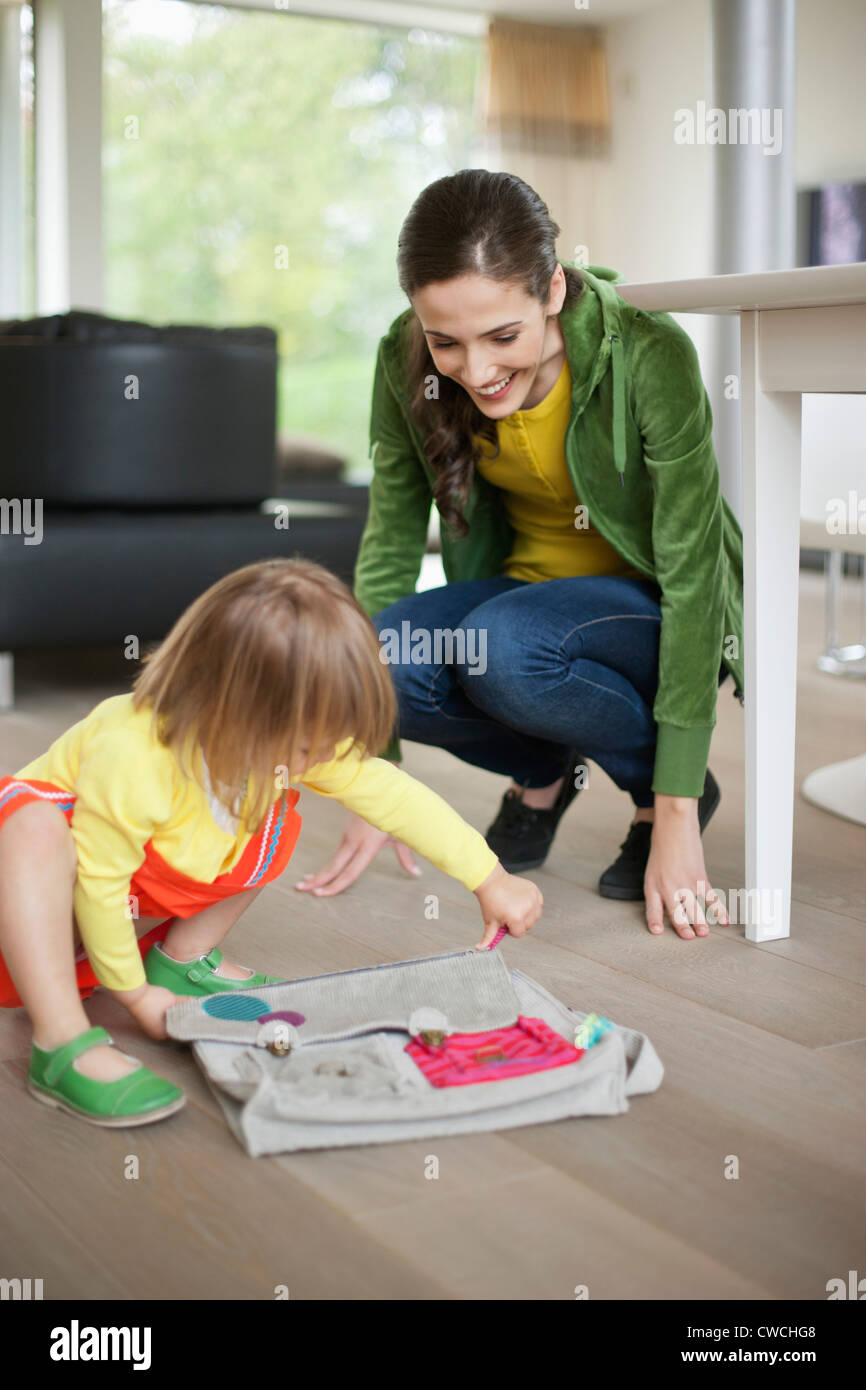 Woman helping her daughter to get ready for school Stock Photo - Alamy