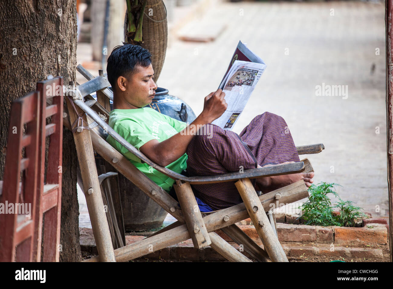 Burmese man reading a newspaper in Bagan, Myanmar Stock Photo - Alamy