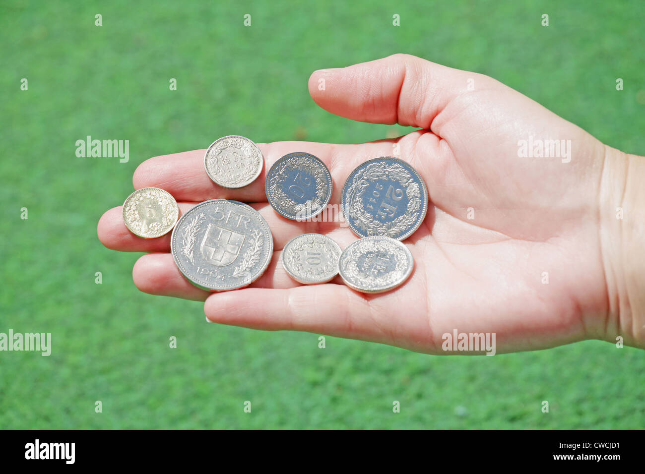 Total set of swiss franc coins hold in open hand Stock Photo - Alamy