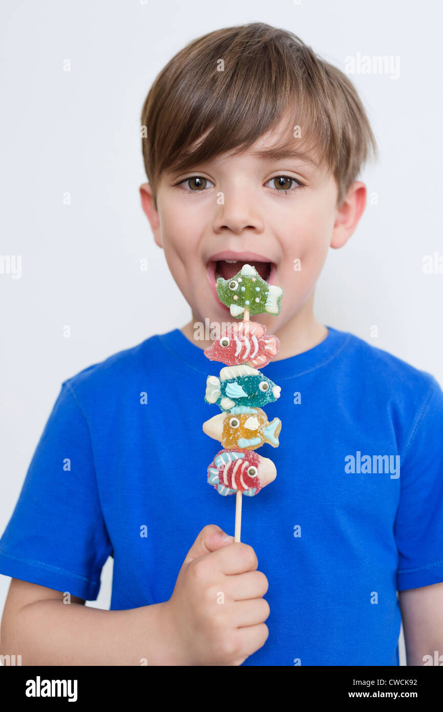 Boy eating candies Stock Photo - Alamy