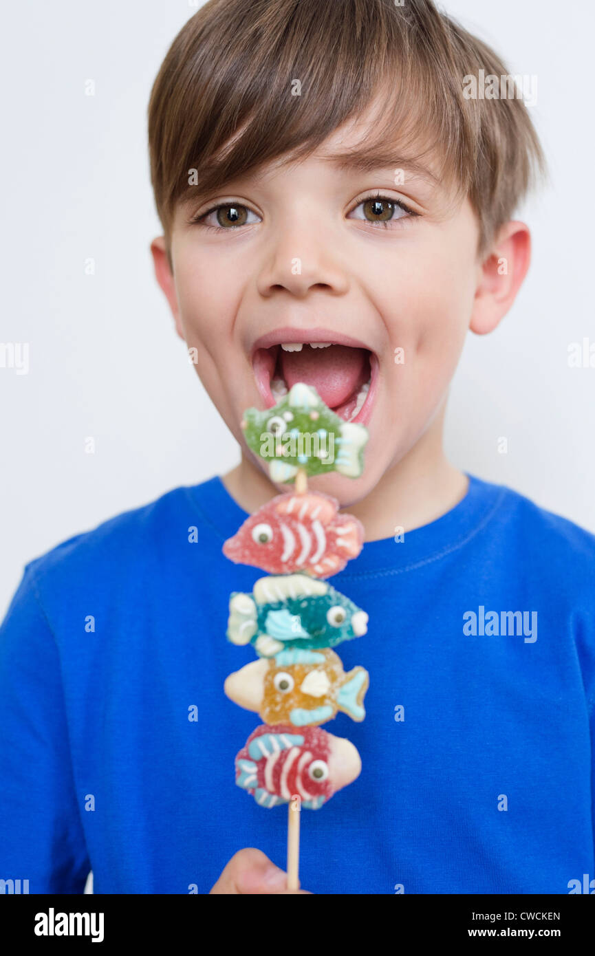 Boy eating candies Stock Photo - Alamy