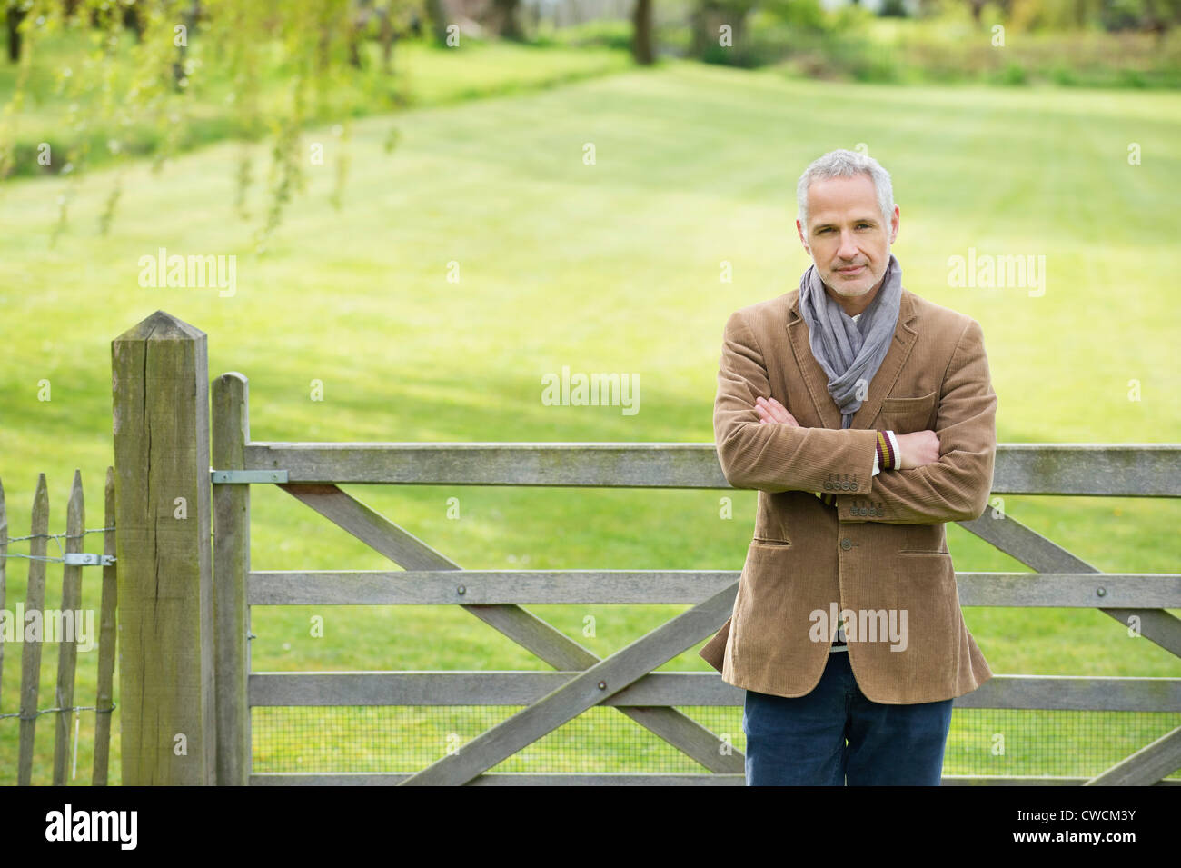 Portrait of a man standing in a park Stock Photo - Alamy
