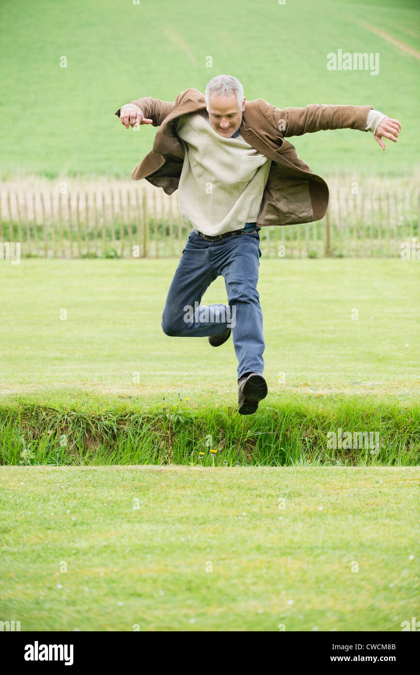 Man jumping in a field Stock Photo - Alamy